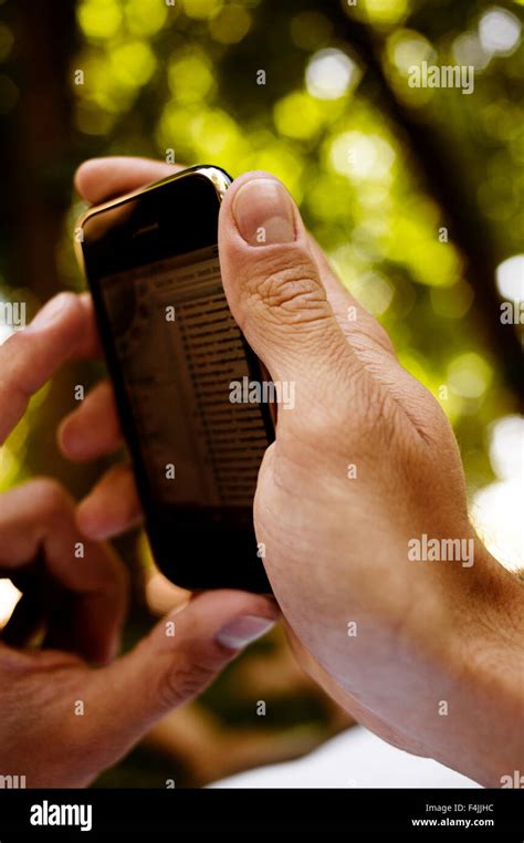 Mans Hands Holding Mobile Phone Stock Photo Alamy