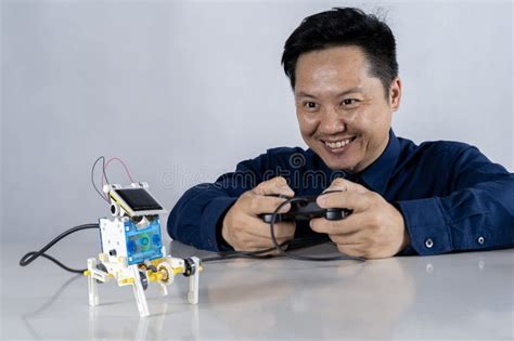 Asian Man Is Building A Robot Project In His Home Robots Control