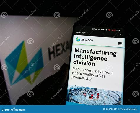 Person Holding Cellphone With Webpage Of Swedish Software Company