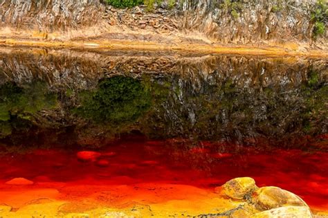 Premium Photo Contrast Of Red Sediments And Reflective Waters In Rio