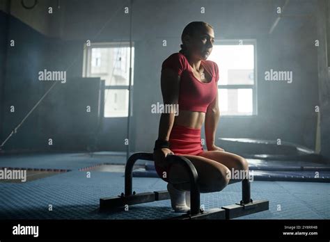 Athletic Female Gymnast In Seated Position Getting Ready To Perform