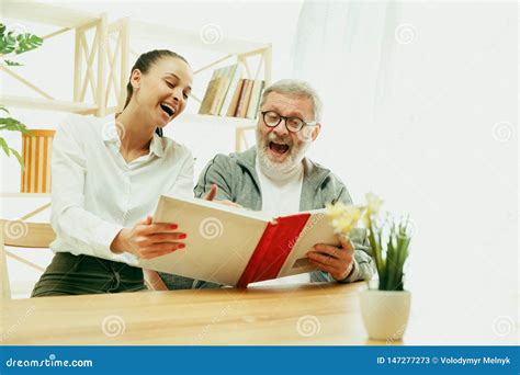 A Daughter Or Granddaughter Spends Time With The Grandfather Stock