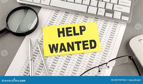 Help Wanted Text Written On A Sticky On Chart With Keyboard And