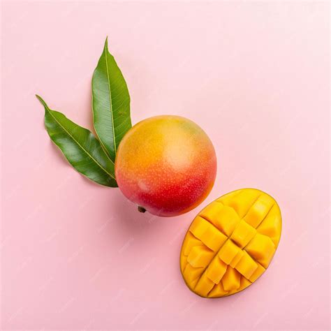 Premium Photo A Mango And A Half Of A Mango Are On A Pink Background