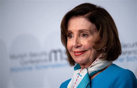 Download Nancy Pelosi In Blue Attire Wearing A Scarf Wallpaper