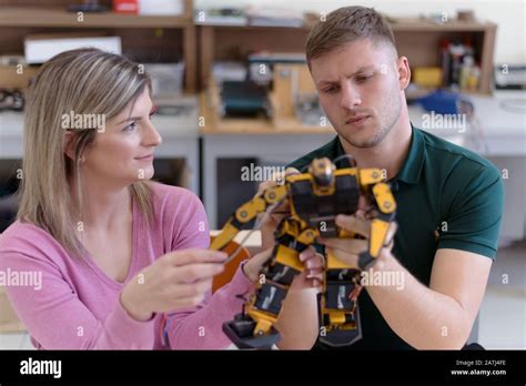 Scientists Engineers Designing Small Human Robot Setting Artificial