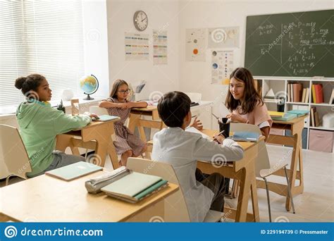 Group Of Intercultural Classmates Interacting At Break Stock Image