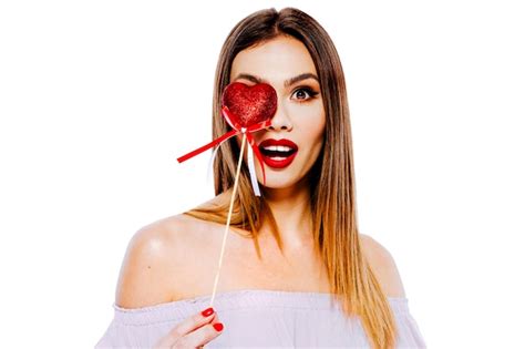 Premium Photo Beautiful Young Woman Model Holding A Red Heart Decoration