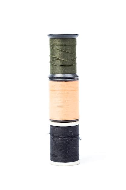 Premium Photo Close Up Of Colorful Thread Spools Against White Background