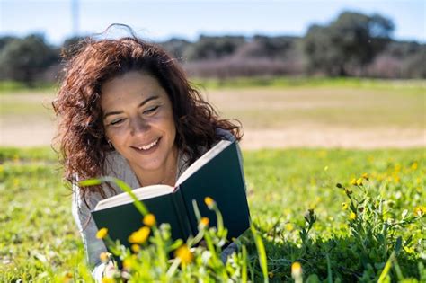 Premium Photo Woman Lying On The Grass Reading A Book