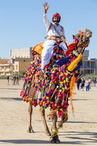전통적인 Rajasthani 드레스를 입고 낙 타 및 인도 남자 Jaisalmer Rajasthan 인도에 사막 축제의 일환으로