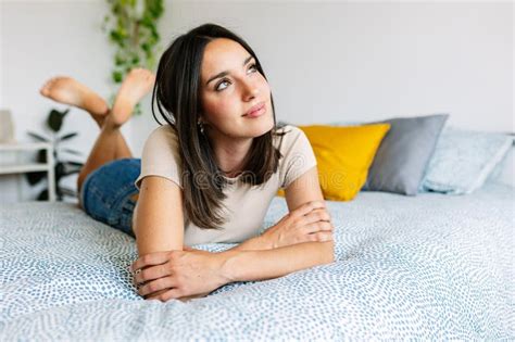 Contemplative Young Beautiful Woman Daydreaming On Bedroom Stock Image