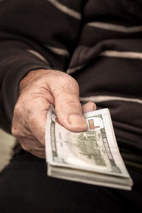 An Elderly Man A Grandfather Holds Money American Dollars In His