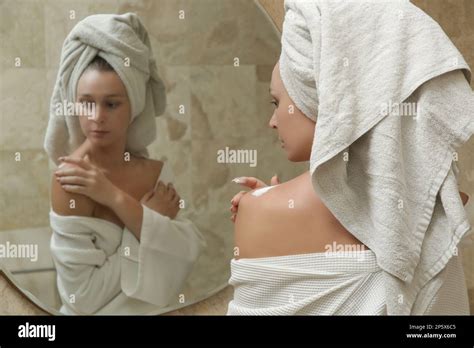 Woman Applying Body Lotion To Moisturize Her Skin After Shower Beauty
