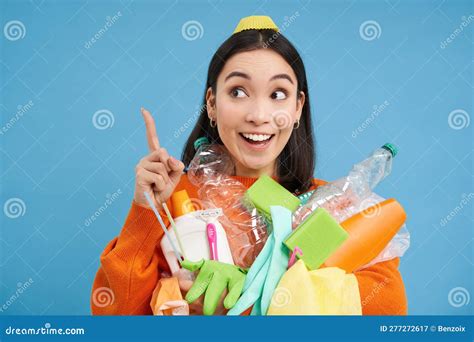Enthusiastic Asian Woman Holding Plastic Empty Bottles And Garbage For