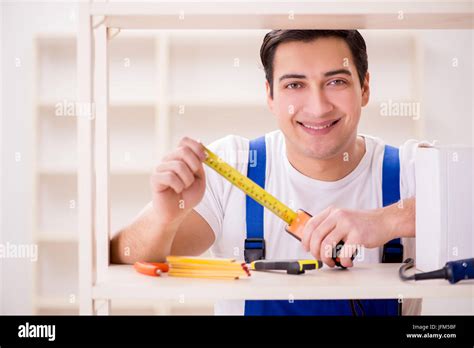 Worker Man Repairing Assembling Bookshelf Stock Photo Alamy