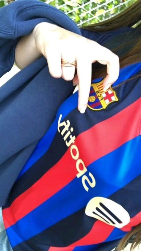 A Person Wearing A Blue And Red Striped Shirt Pointing At Something