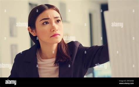 Asian Architect Examines Industrial Blueprints And Maquette To Calculate Real Measurements And