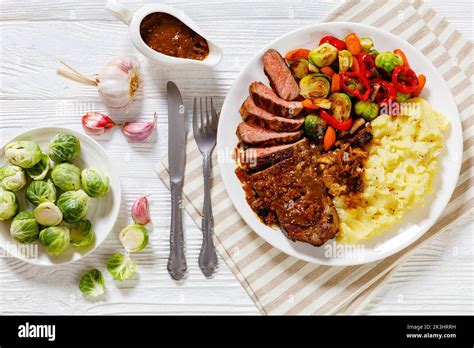 Medium Rare Beef Steak With Brown Gravy And Mashed Potato Roasted Brussels Sprouts Pepper And