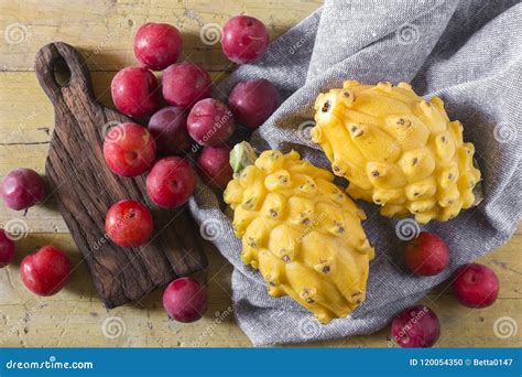 Fruta Amarilla Del Pitahaya O Del Dragón Y Ciruelo Rojo En De Madera