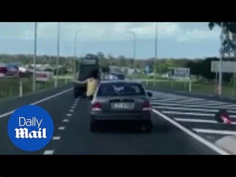 Shocking Footage Shows Woman Hanging Out The Window Of A Moving Car