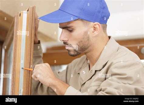 Man Is Fixing A Window Frame Stock Photo Alamy