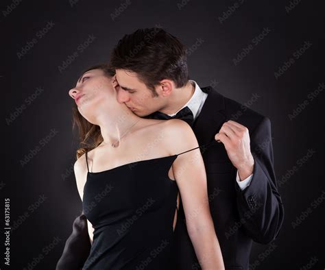 Man Kissing Woman On Neck While Removing Dress Strap Stock Photo Adobe Stock