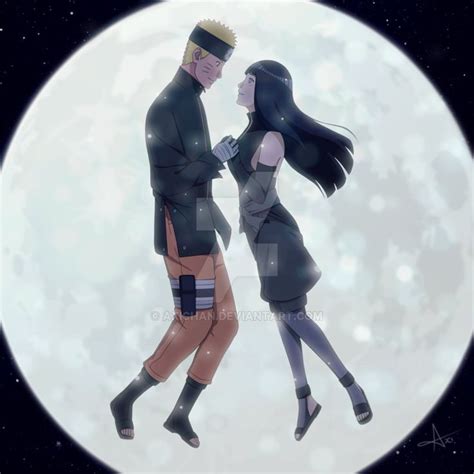 Two People Standing Next To Each Other In Front Of A Full Moon With