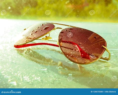 Stylish Pink Sunglasses With Drops Of Water The Concept Of Leisure