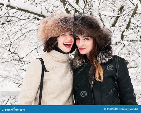Adorable Happy Young Brunette Women Girlfriends In Fur Hats Having Fun