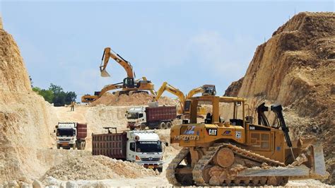 Cat 320d Excavator Loading Limestone Into Hino Dump Trucks Youtube