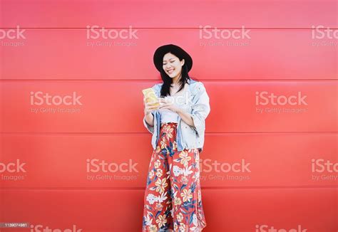 행복 한 아시아 여자 휴대 전화를 사용 하 여 야외중국 사회 영향력 새로운 트렌드와 재미 스마트폰 앱제너 레이 션 Z 미디어