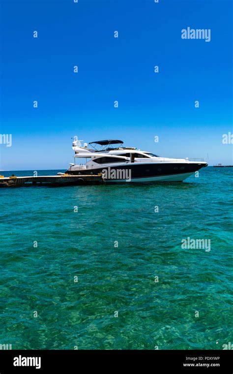 White Yacht Drifting In The Waters Of The Red Sea With View To Wooden