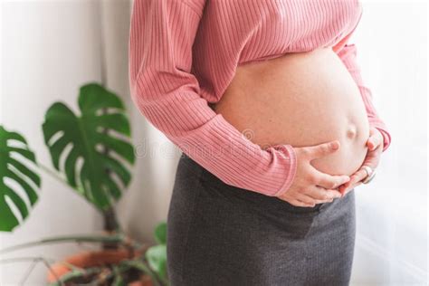 Pregnant Woman Standing And Touching With Her Hands Her Big Naked Belly