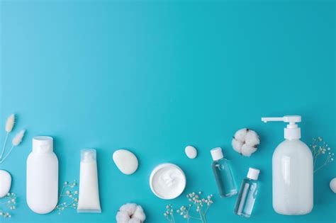 Premium Photo Cosmetic Skin Care Products With Flowers On Blue Background Flat Lay Copy Space