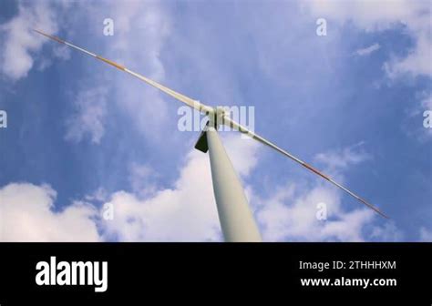 Bottom Up View Of New White Modern Wind Turbine Farm Power Generation Station Against Clear Blue