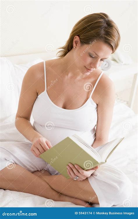 Pregnant Woman In Bedroom Reading Book Stock Photo Image Of Seated Book