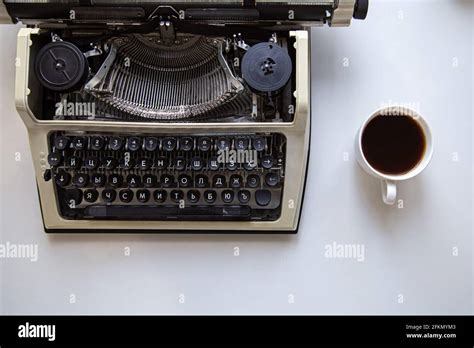 Old Fashioned Manual Typewriter And Cup Of Black Coffee On The Desk Top
