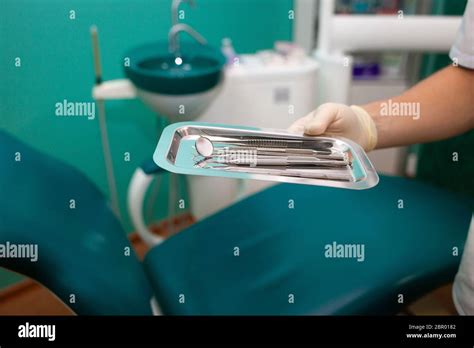 Dentist Doctor Holds Many Dental Instruments In His Hands Sterile