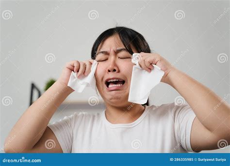 Portrait Of A Sad Asian Woman Crying Wipes Her Tears With A Tissue