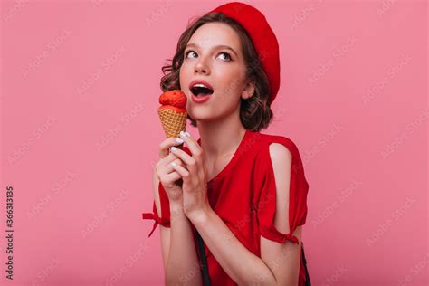 Cheerful Brunette Girl In Red T Shirt Posing With Ice Cream Indoor