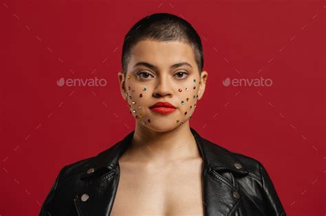 Beautiful Shaved Head Woman With Shiny Crystals Over Her Face Standing