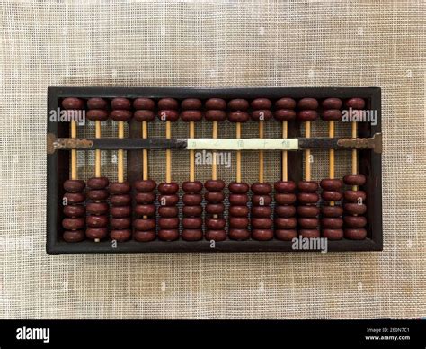 Close Up Of An Abacus Ancient A Calculating Tool Isolated On A Mat High Quality Photo Stock