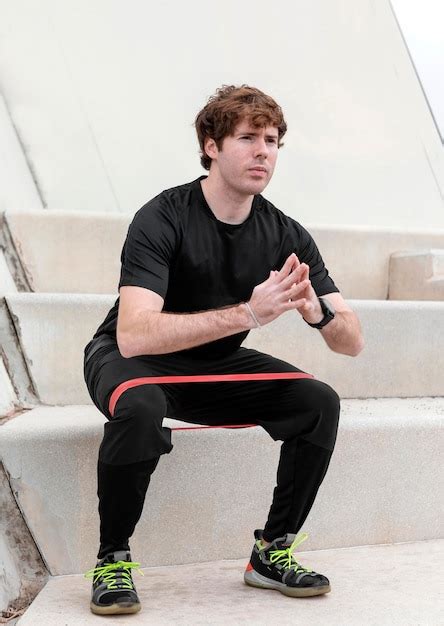 Premium Photo Young Man In Sportswear Exercising Outdoors
