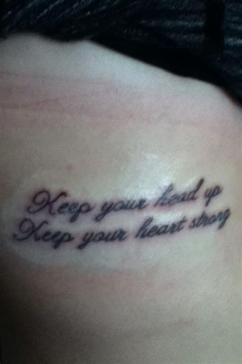 A Woman With A Tattoo Saying Keep Your Head Up