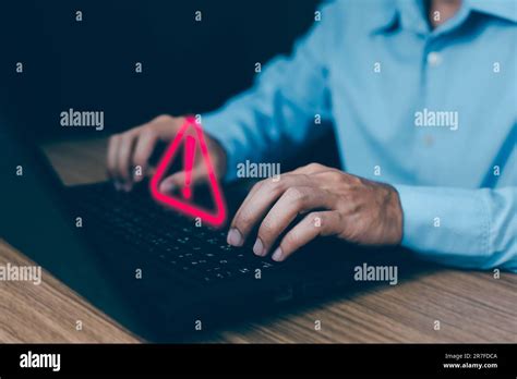 Businessman Using Computer Laptop With Triangle Caution Warning Sing