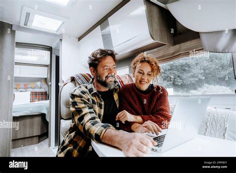 Happy Travel Couple Lifestyle Smile And Use Laptop Together Inside A