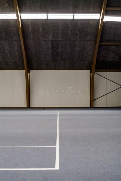 Vertical Shot Of An Indoor Basketball Court With Symmetrical Patterns
