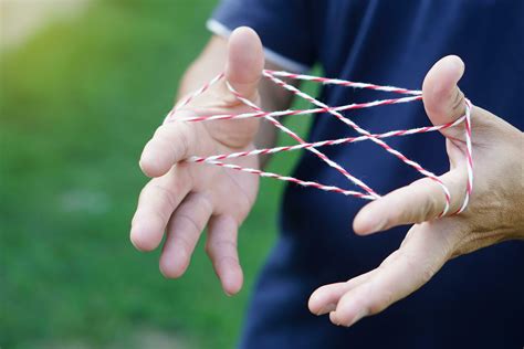 Closeup Man Hands Is Playing Rope Which Called Cats Cradle Game