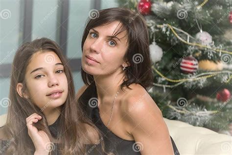 Mamá Y Su Hija Cerca Del árbol De Navidad Están Sentadas En El Sofá